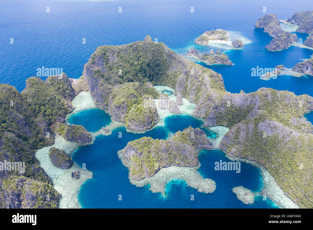Highly eroded limestone islands rise from the beautiful, tropical ...