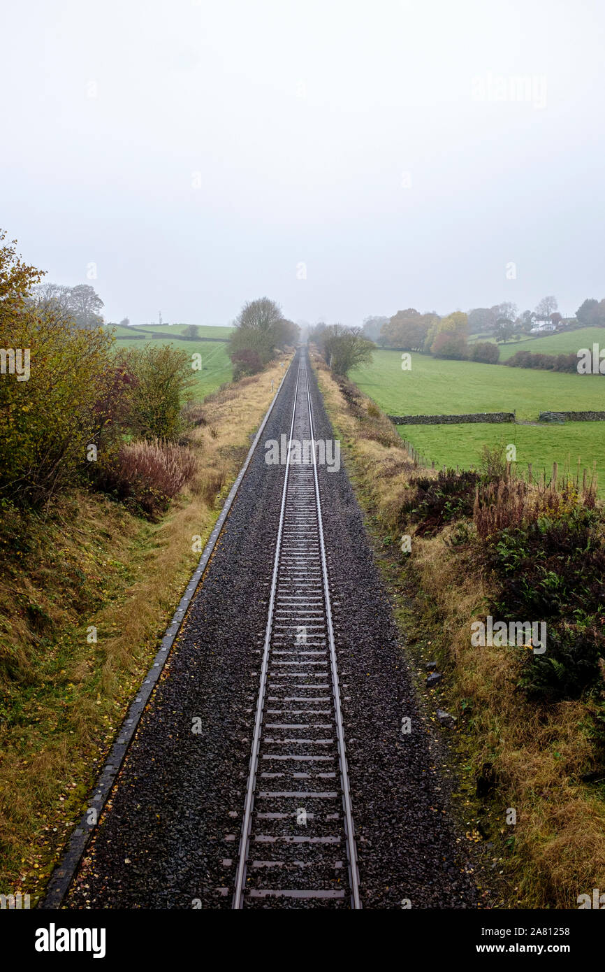 Single track railway line on a misty autumn morning Stock Photo - Alamy