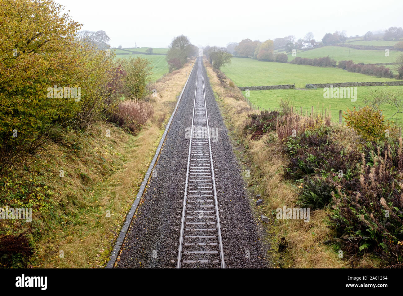 Single track railway line on a misty autumn morning Stock Photo - Alamy
