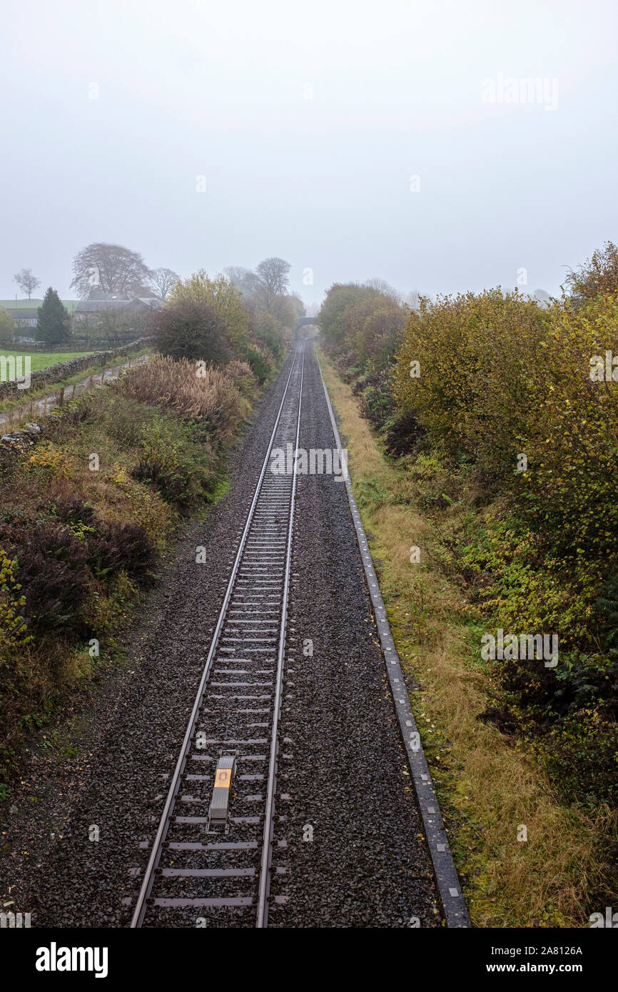 Single track railway line on a misty autumn morning Stock Photo - Alamy