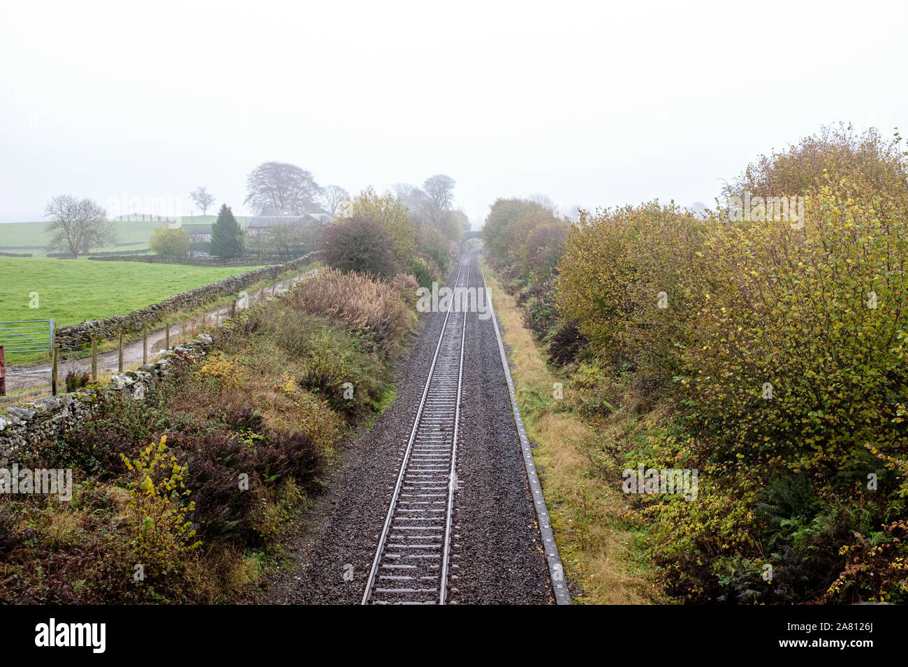 Single track railway line on a misty autumn morning Stock Photo - Alamy