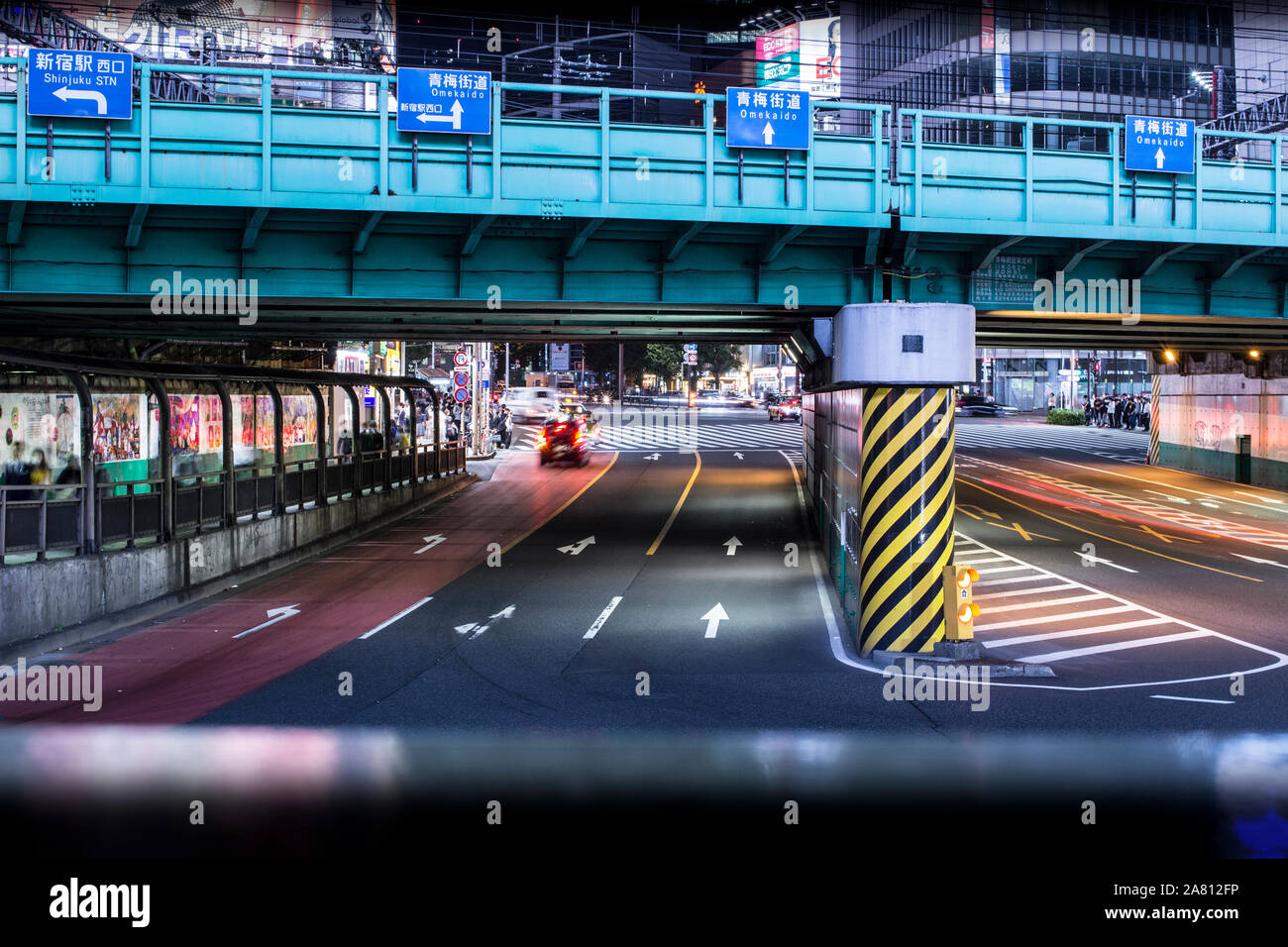 Tokyo by night -Shinjuku streets, Railway overpass with road signs ...