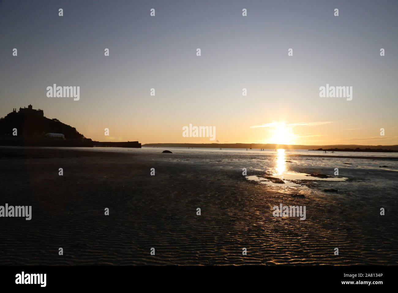 Sun setting over sea at St Michaels Mount Stock Photo - Alamy