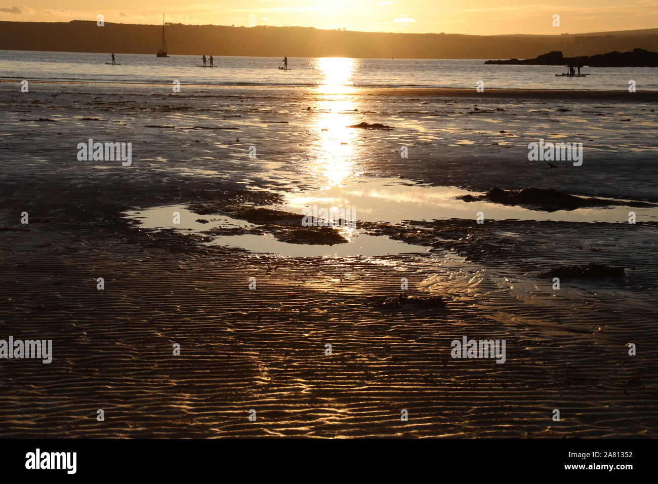 Sunset over Cornish Beach with boats Stock Photo - Alamy