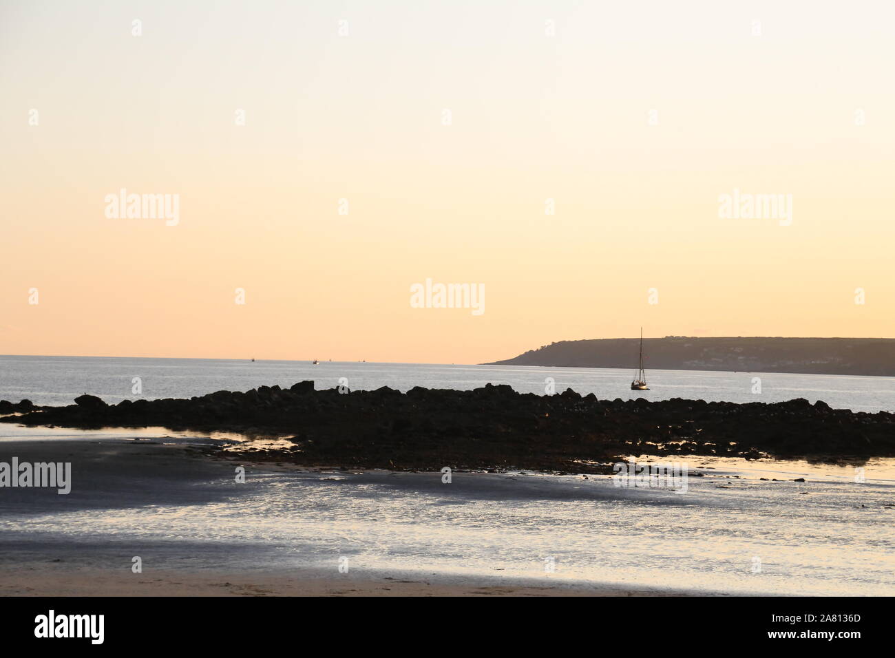 Sun setting over sea Stock Photo - Alamy