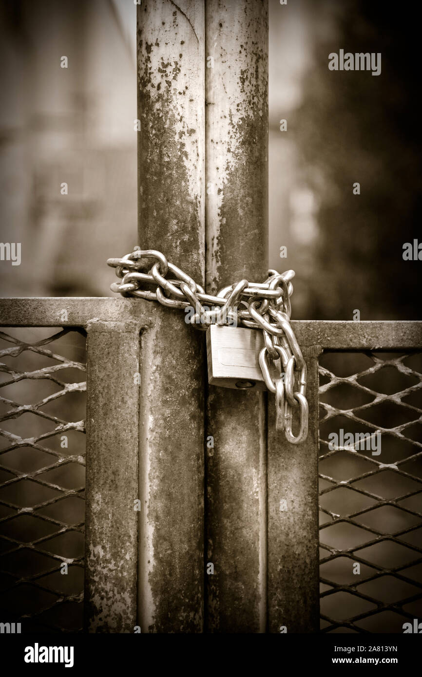 Rusty metal gate closed with padlock - concept image with copy space ...