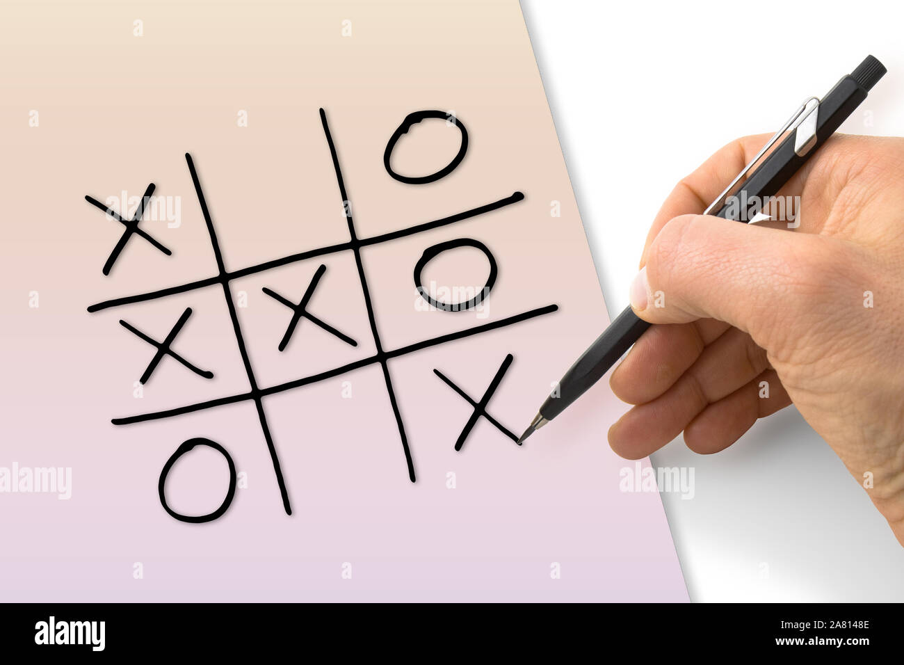 Hand draws the tris game on colored sheet - concept image Stock Photo ...