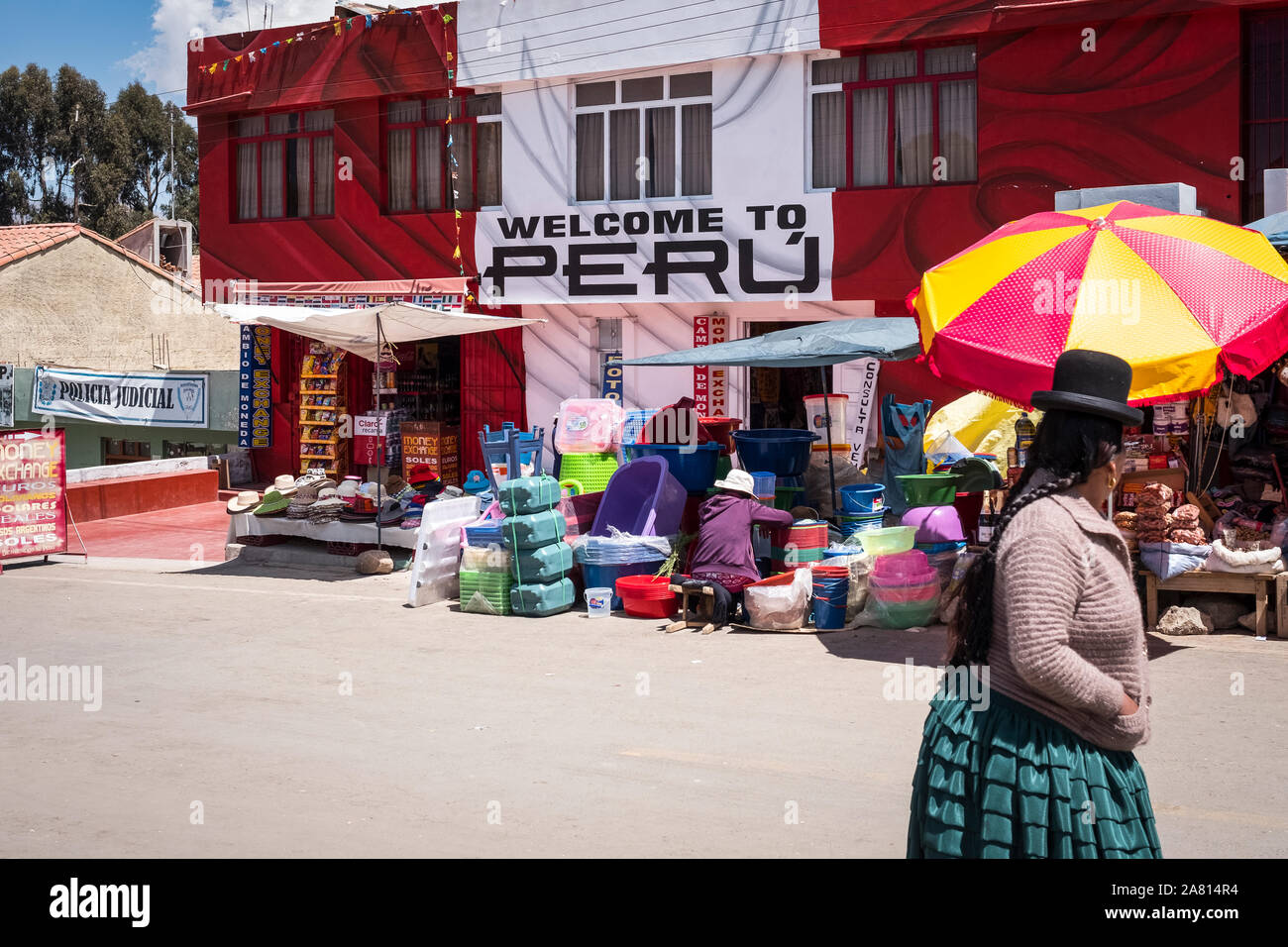 People walking in front the Peru Customs building on the Peru-Bolivia ...