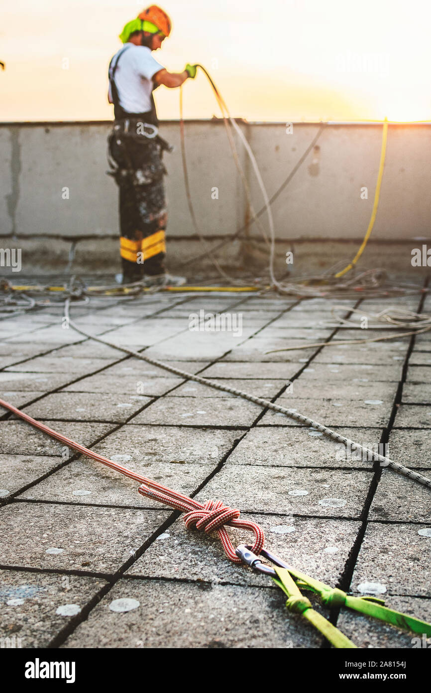 Industrial rope access worker wearing professional safety gears ...