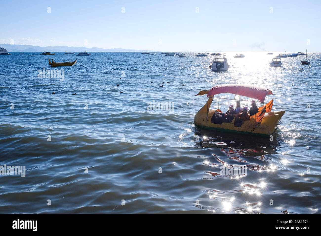 Local people riding on a duck-shaped boat in Copacabana beach, Bolivia ...
