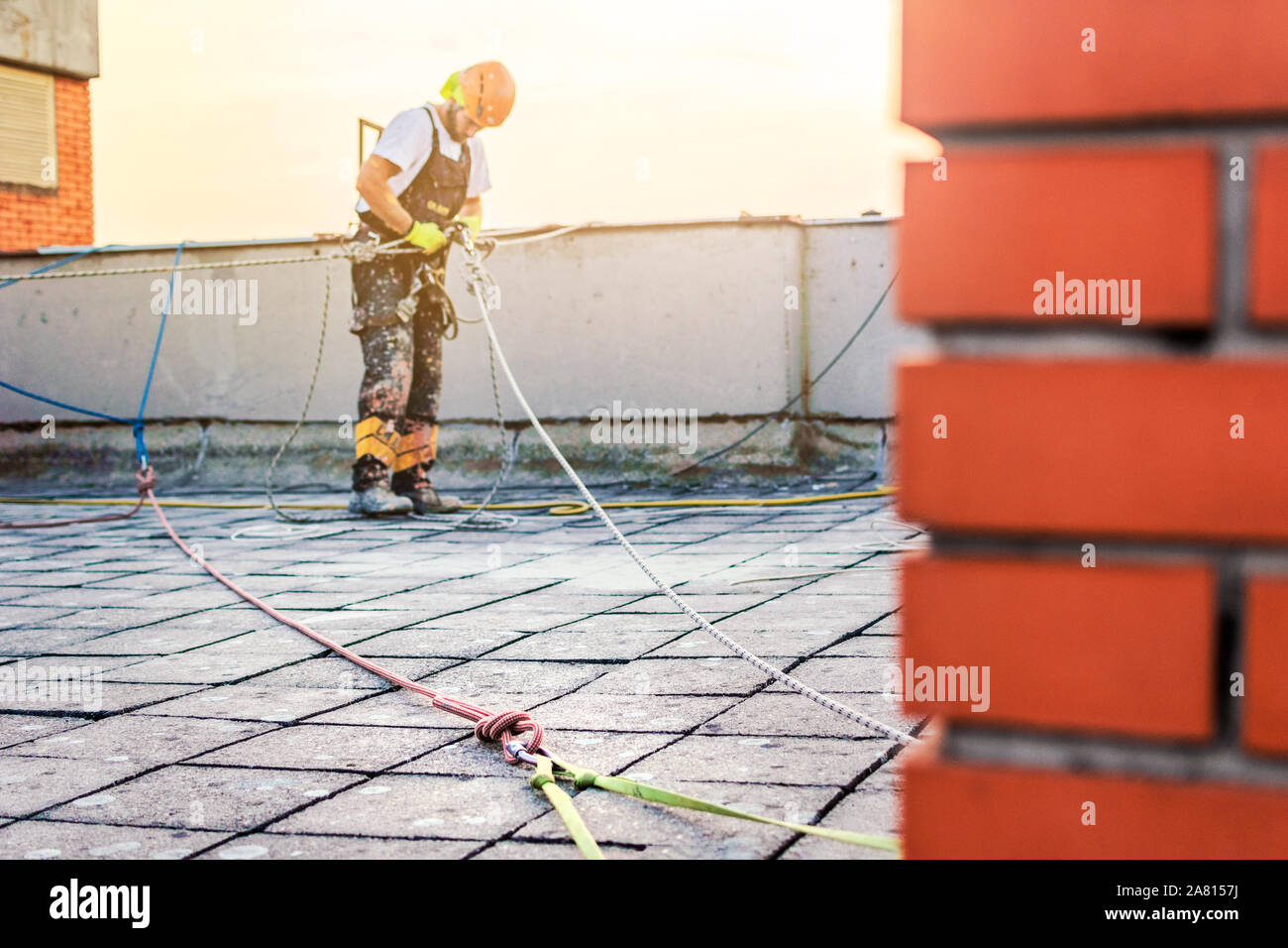 Industrial rope access worker wearing professional safety gears ...