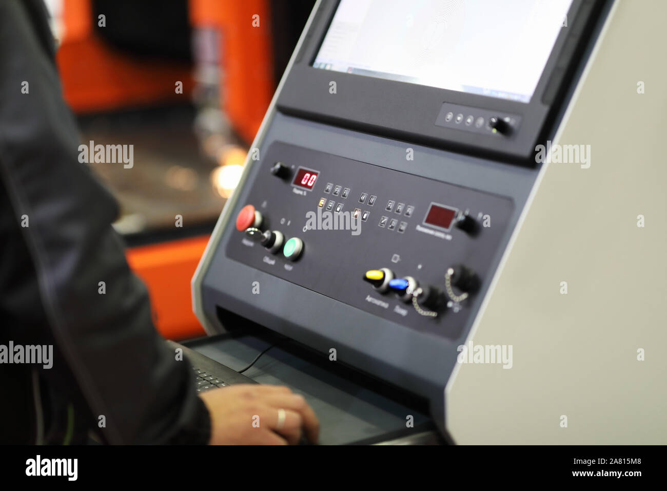 Operator working with a control panel of CNC laser metal cutter ...