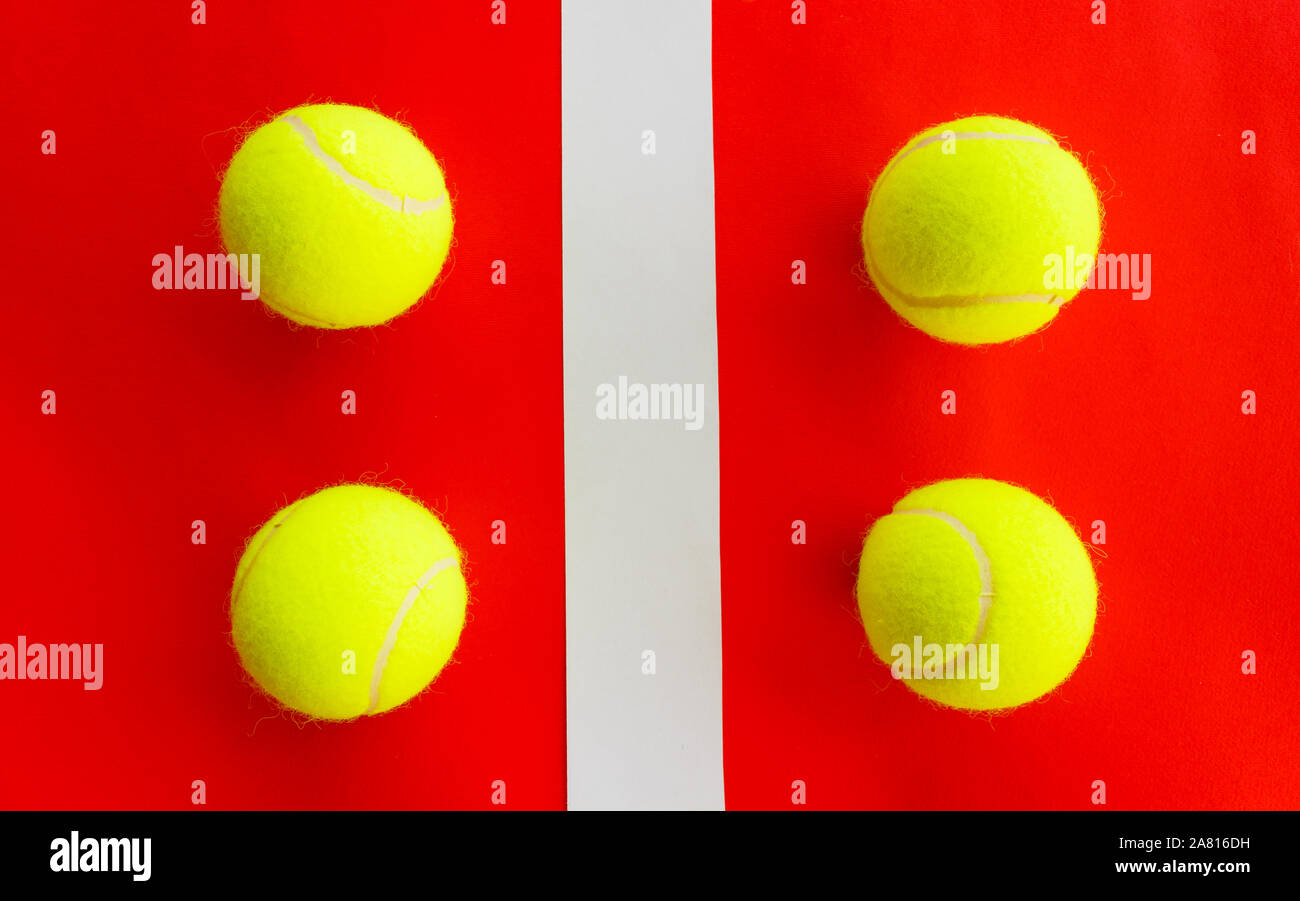four tennis balls divided by a field line they represent a double ...