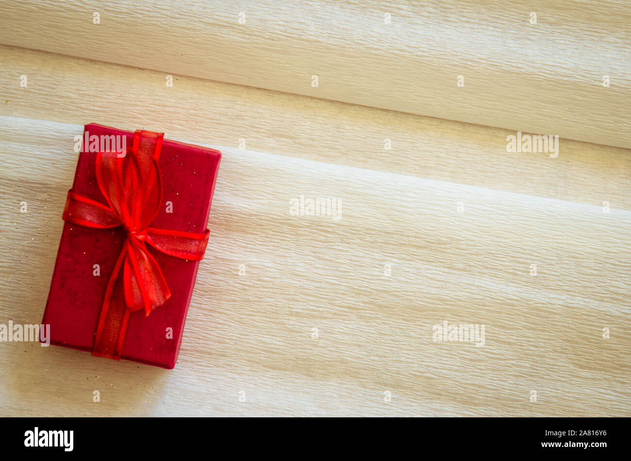 present in red box with red ribbon on white background Stock Photo - Alamy