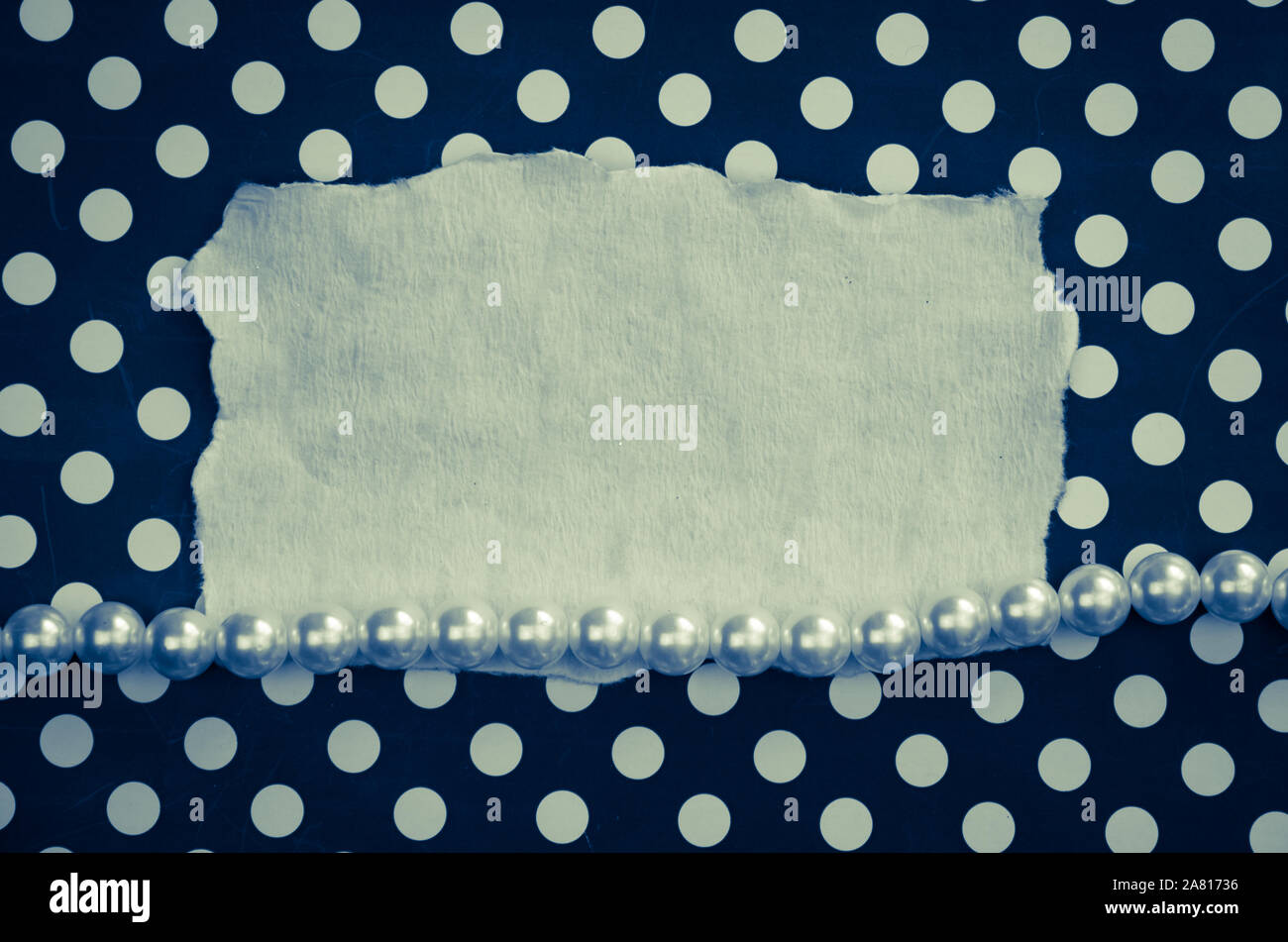 pearls, blank board and white blue dotted background Stock Photo - Alamy