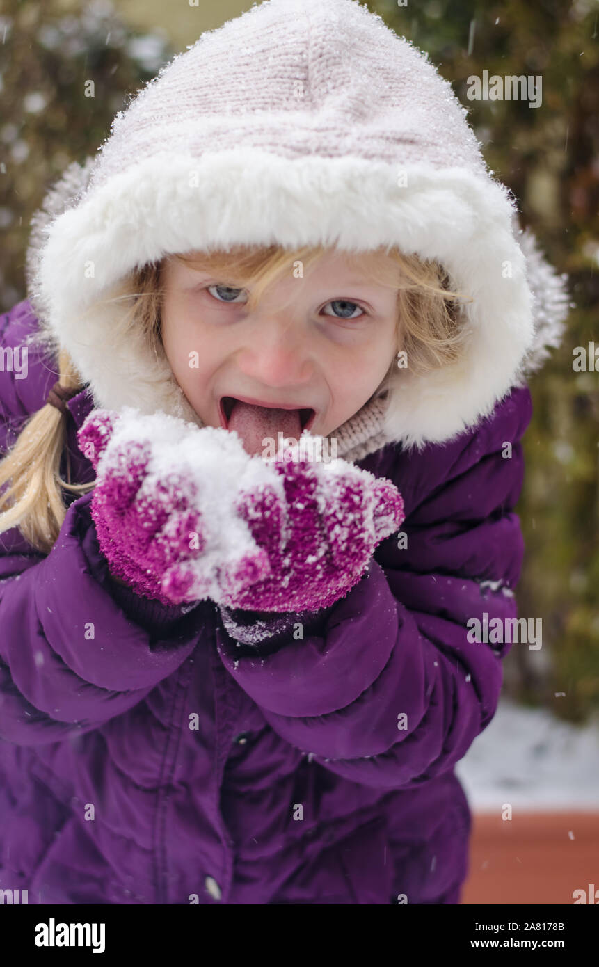 lovely little kid playing with snow Stock Photo - Alamy