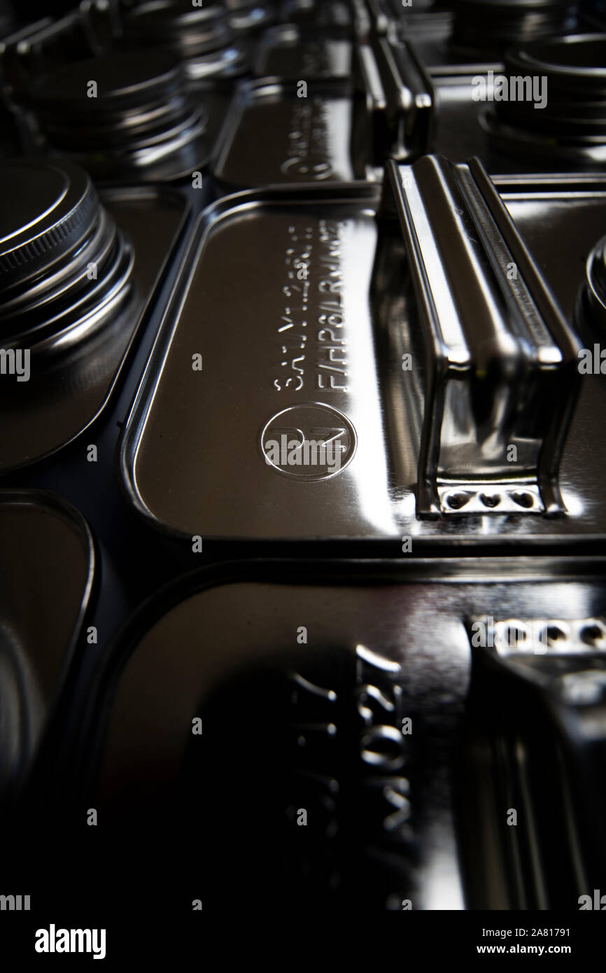 stainless steel jerry cans stacked in warehouse, close up with shallow ...
