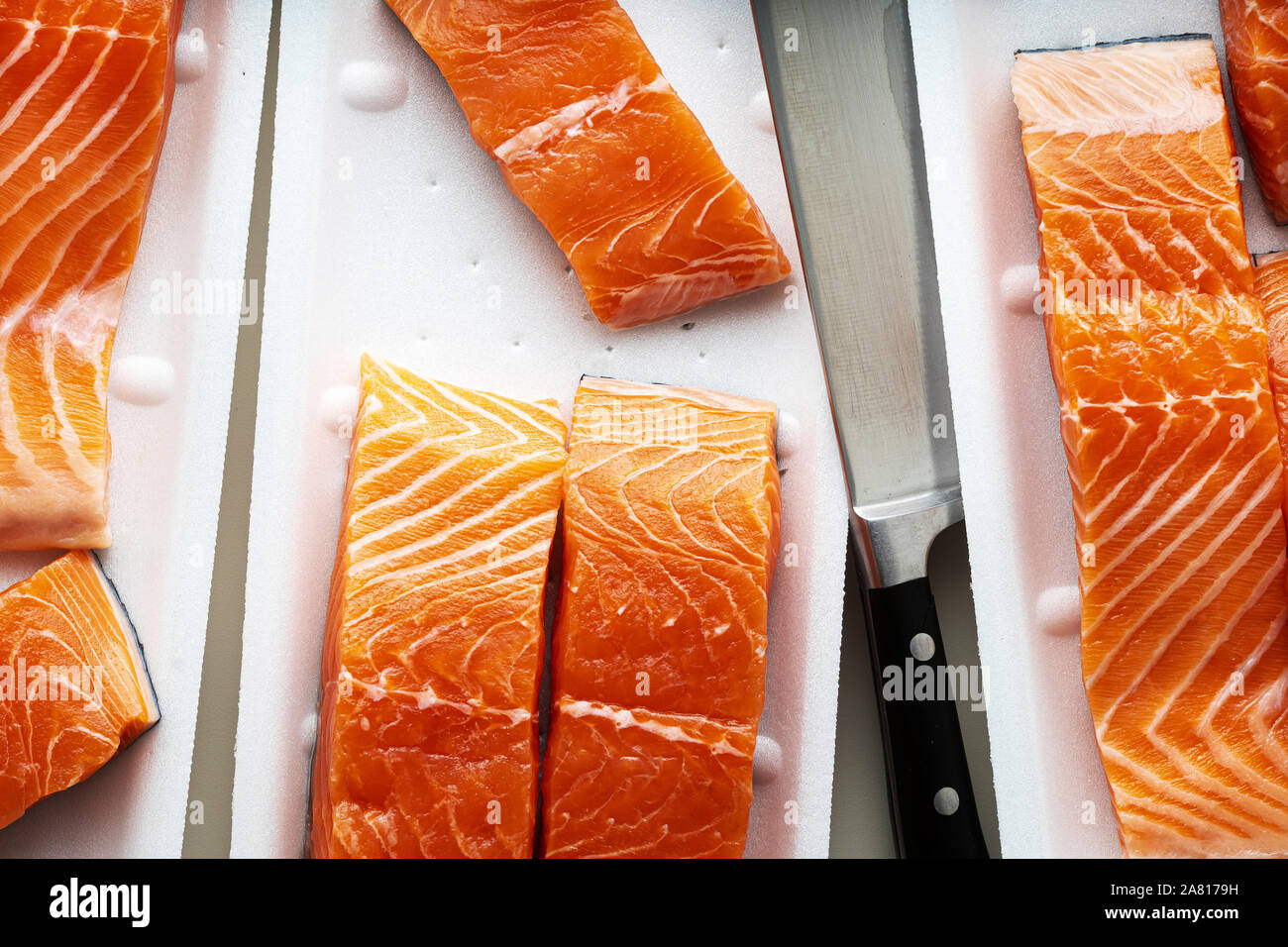 fresh salmon, cut into pieces and ready for cooking. fish cutting, and ...