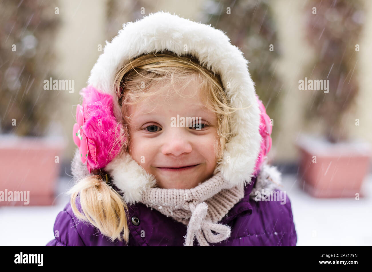 lovely little kid playing with snow Stock Photo - Alamy