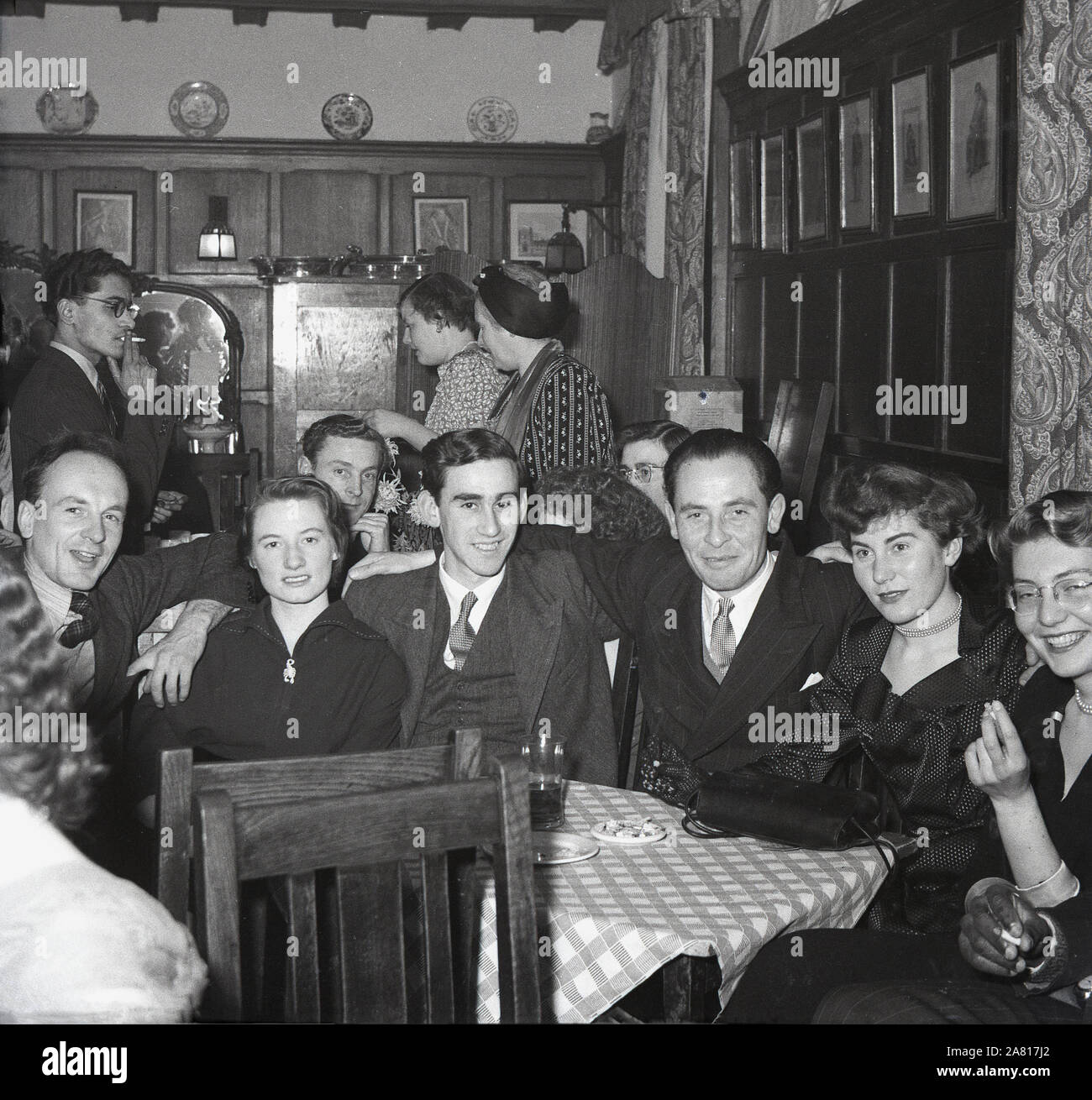 1950s, historical, several well-dressed ladies and gentlemen having a ...