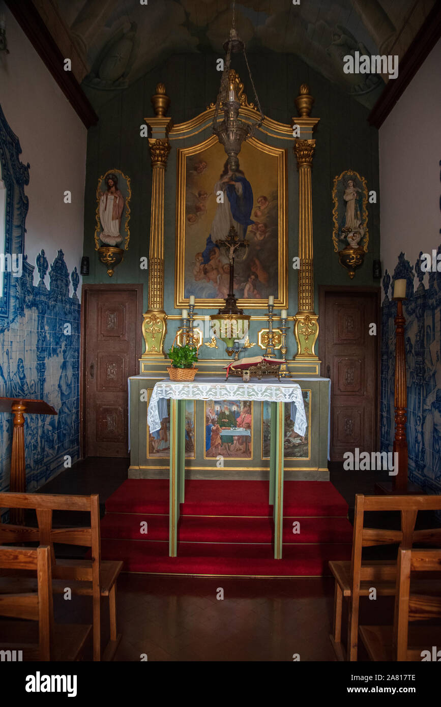 The interior of a traditional chapel with religious artwork, an altar ...