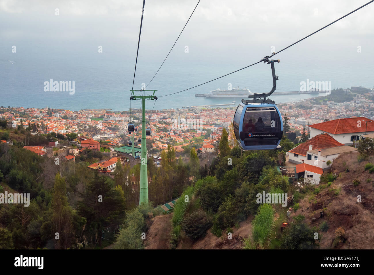 A scenic view of the cable car in Funchal, Madeira, with its cabins ...