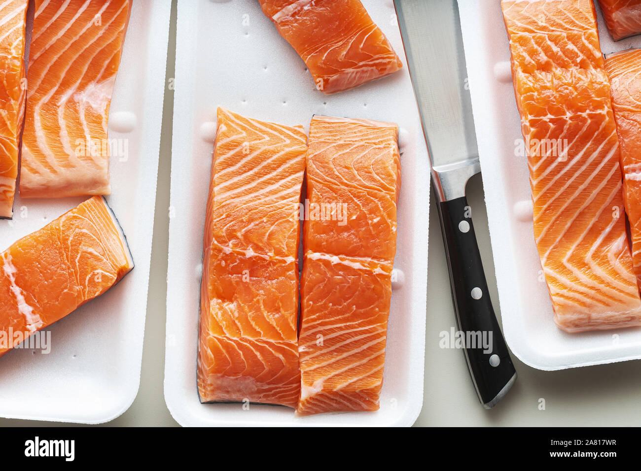 fresh salmon, cut into pieces and ready for cooking. fish cutting, and ...