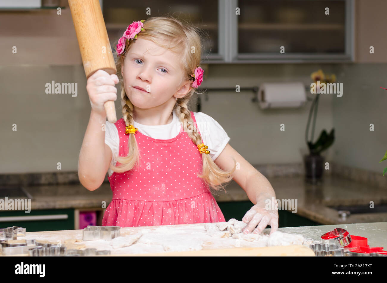 beautiful little girl in kitchen with rolling pin Stock Photo - Alamy