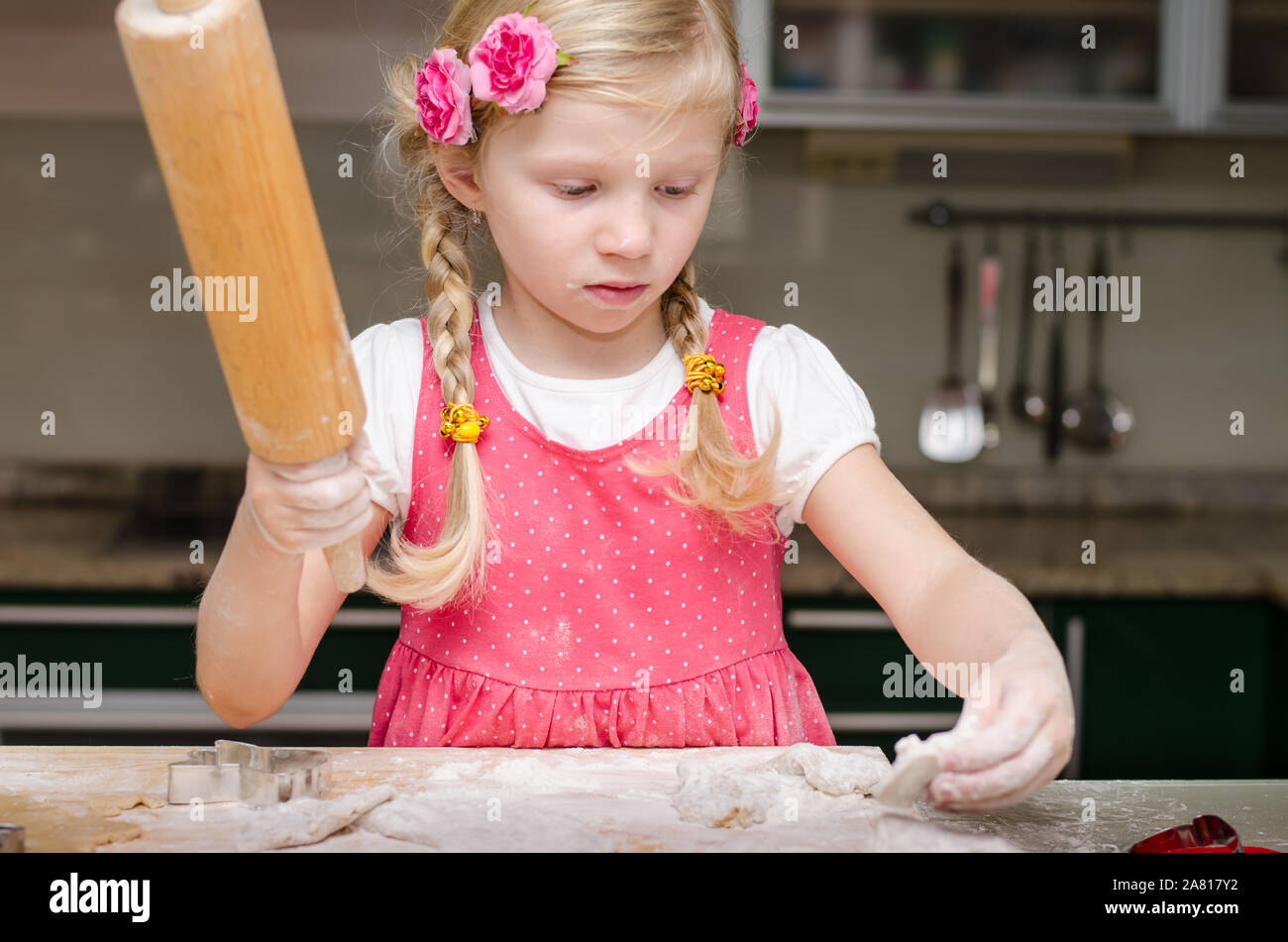 beautiful little girl in kitchen with rolling pin Stock Photo - Alamy