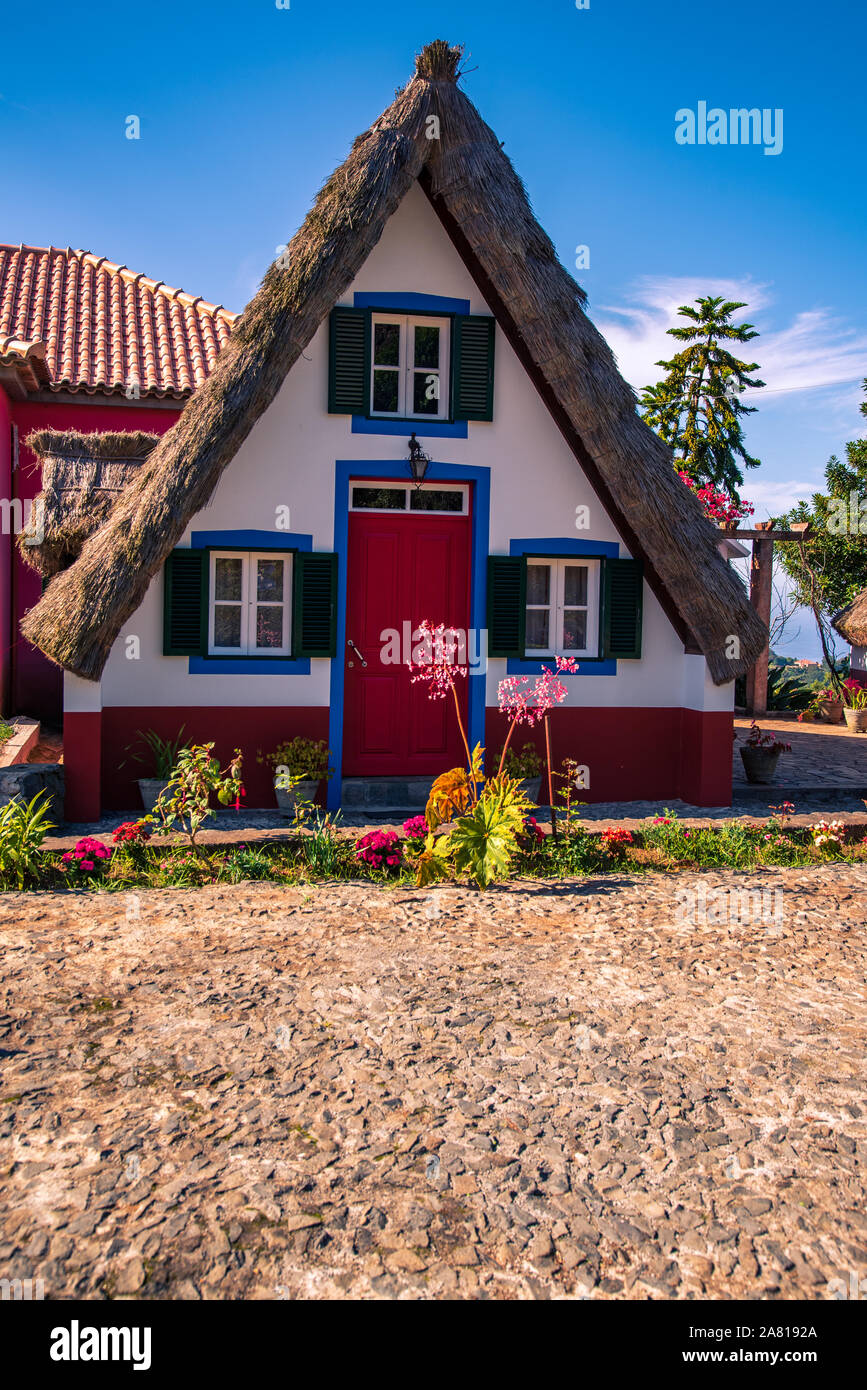 colorful traditional thatched house in Santana, Madeira, with a ...