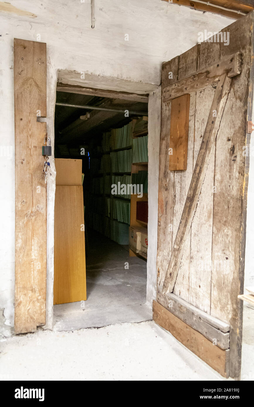Old wooden door, open, leading to an archive Stock Photo - Alamy