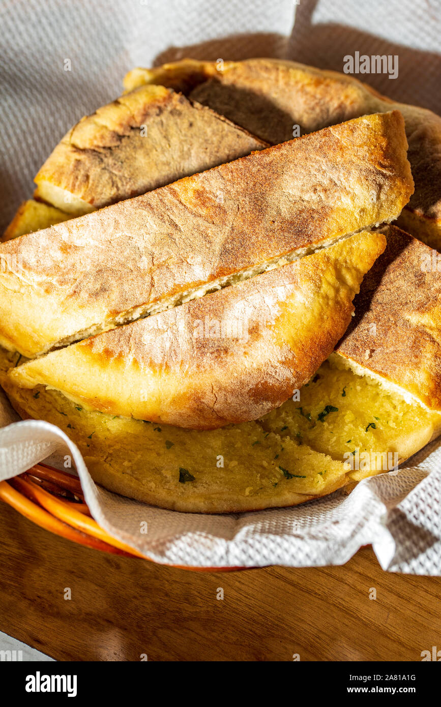 Traditional Madeiran flatbread known as bolo do caco, served warm with ...