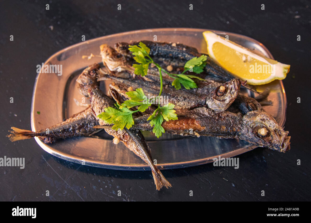 Plate of fried little chicharro fish with lemmon and parsley Stock ...