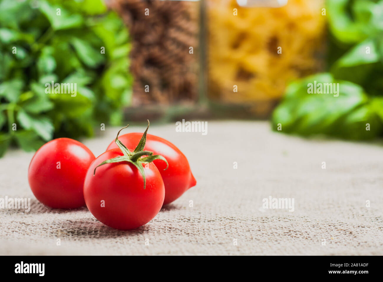 Ingredients of the cook - pasta, garlic, basil and tomato - a blurry ...