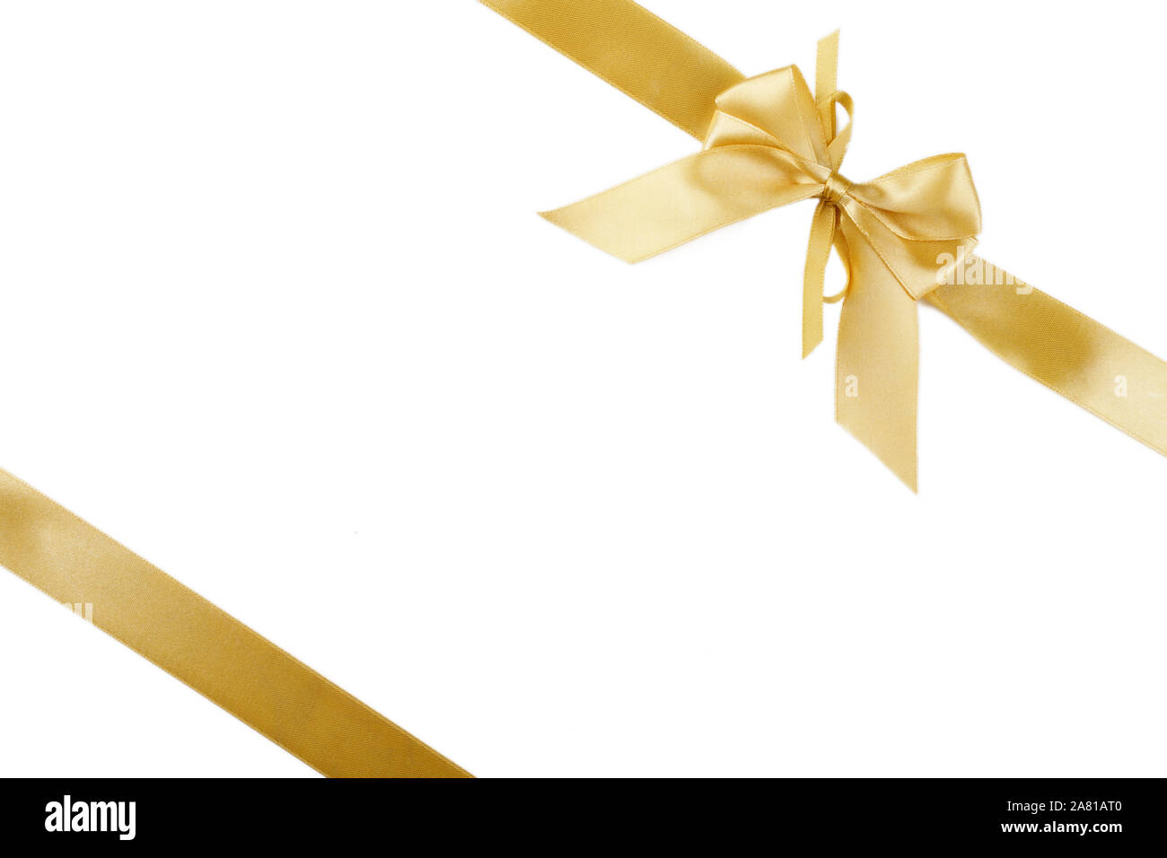 Gold satin ribbon with bow isolated on white Stock Photo - Alamy