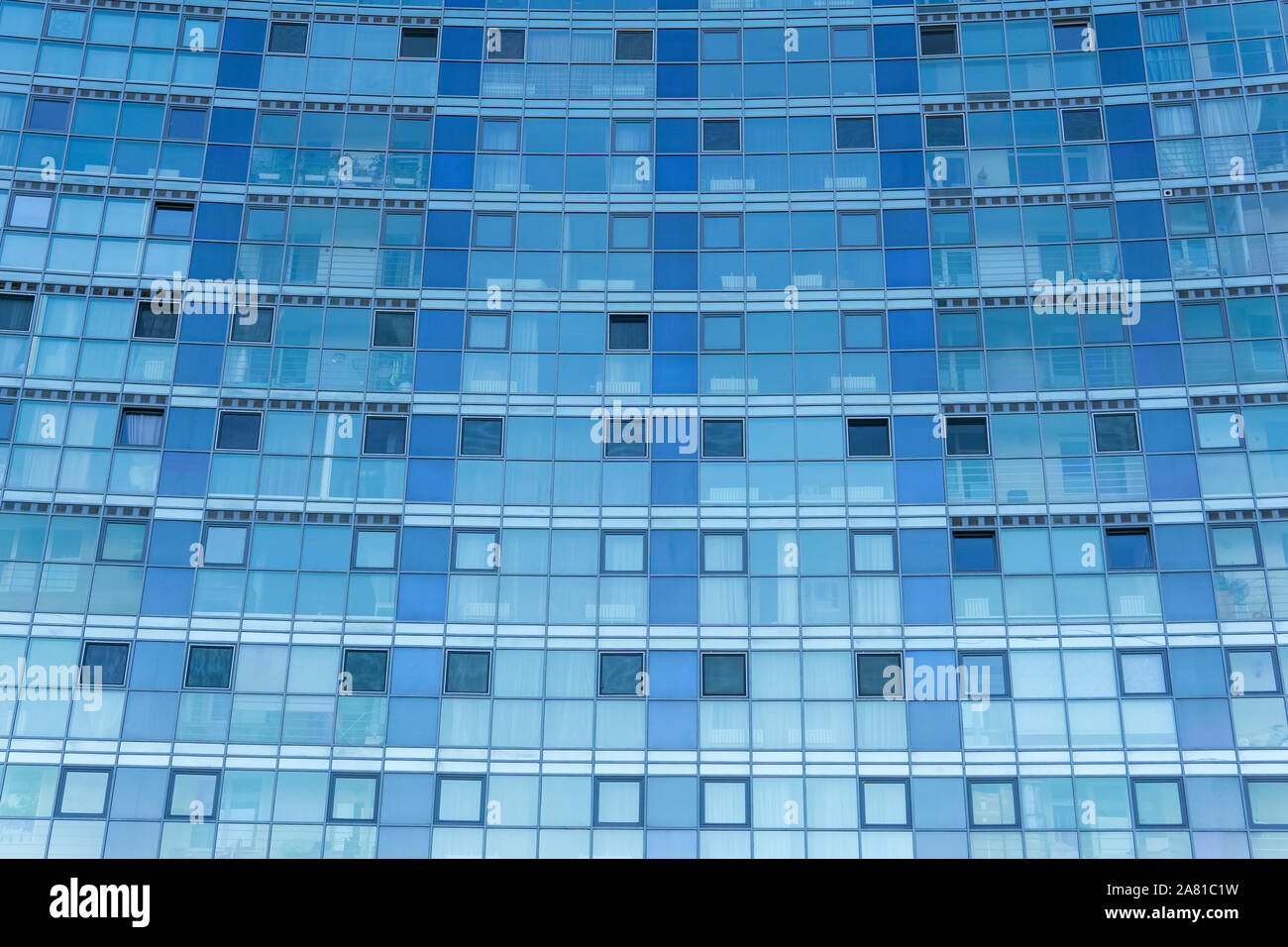 blue urban background - glazed facade of a modern multi-storey building ...