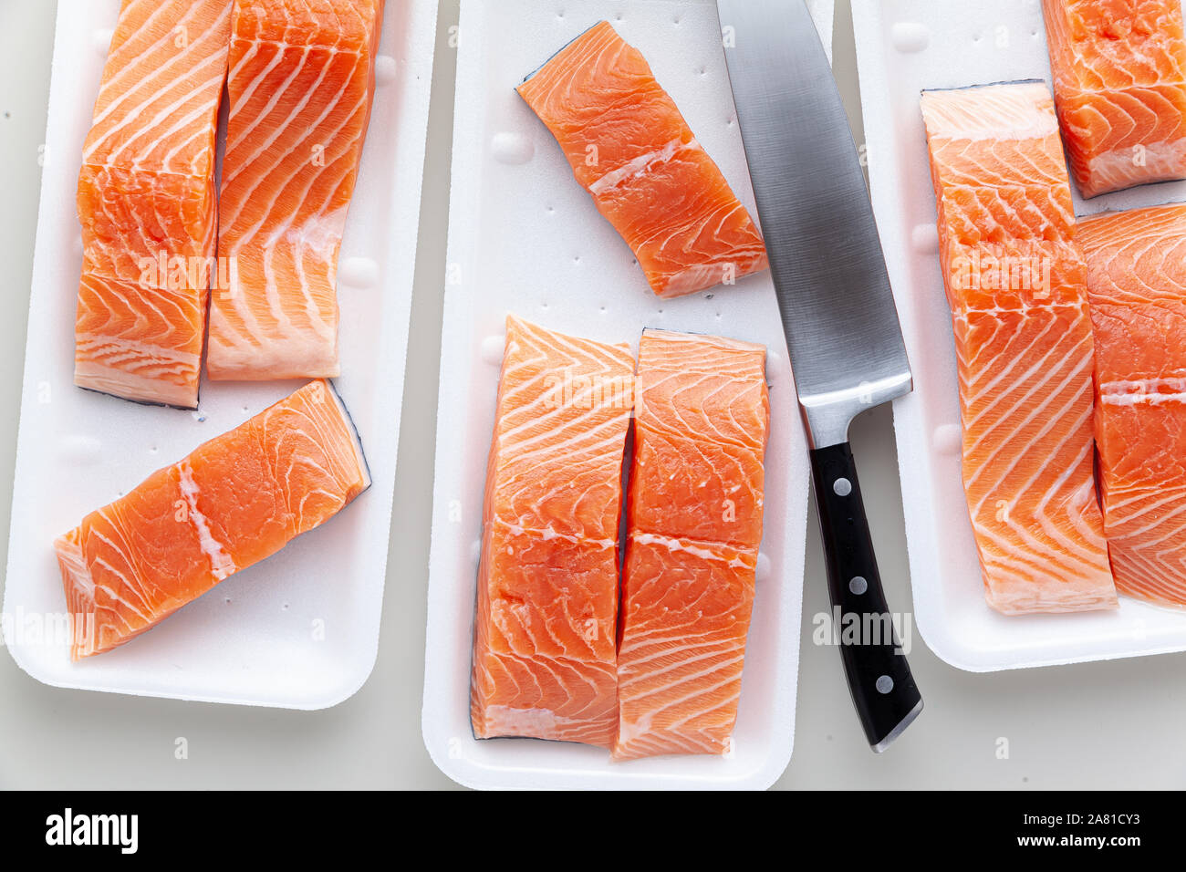 fresh salmon, cut into pieces and ready for cooking. fish cutting, and ...