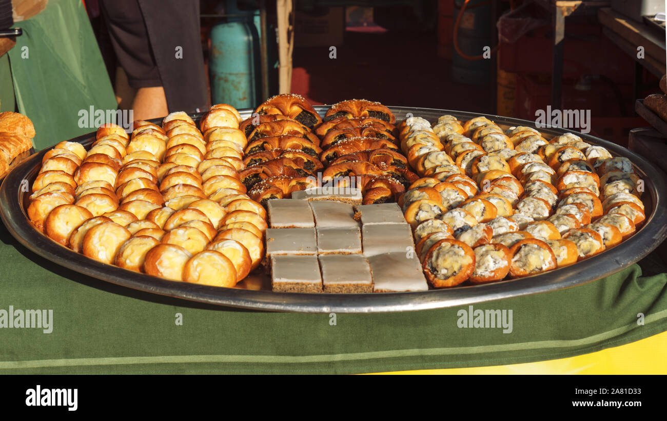 Traditional sweet and salty pastries at farmers street food market or ...