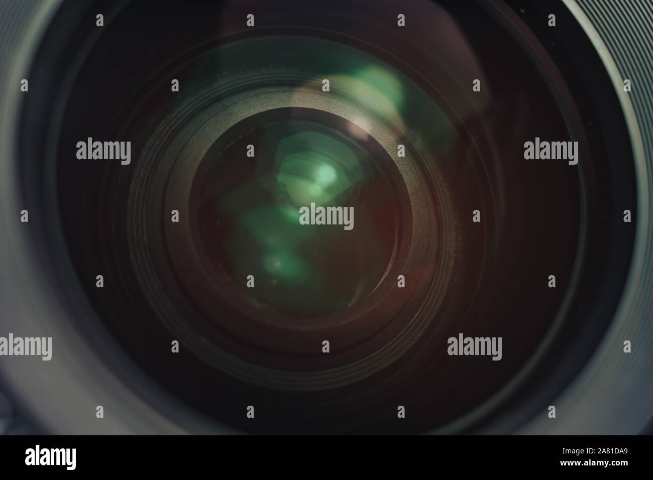 Beautiful camera lens with yellow and pink light of glass on a black ...