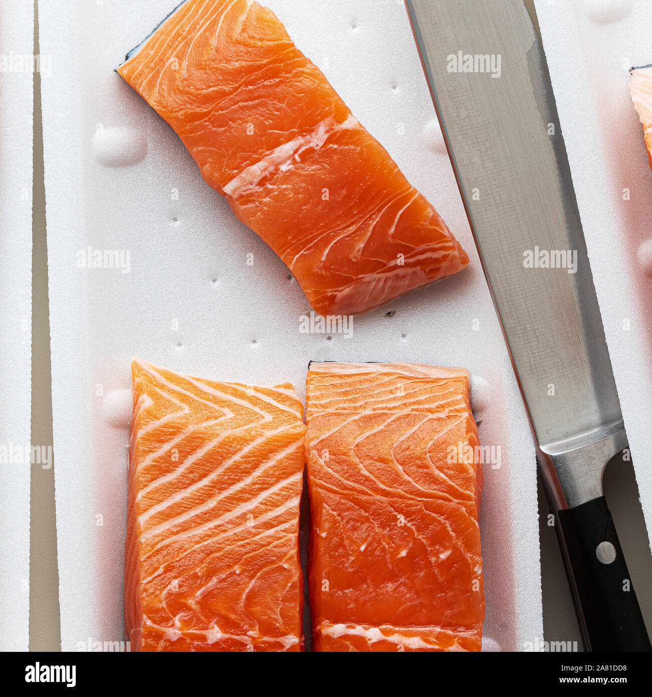 fresh salmon, cut into pieces and ready for cooking. fish cutting, and ...