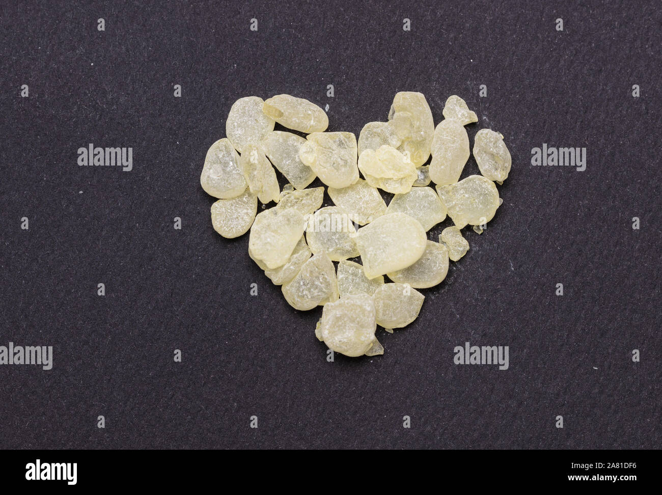Mastic resin tears. Chios mastic heart shape pile on gray black ...