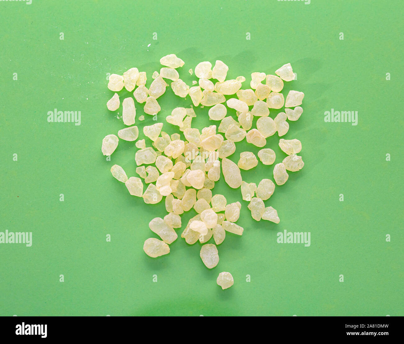 Mastic resin tears. Chios mastic on green color background, top view ...