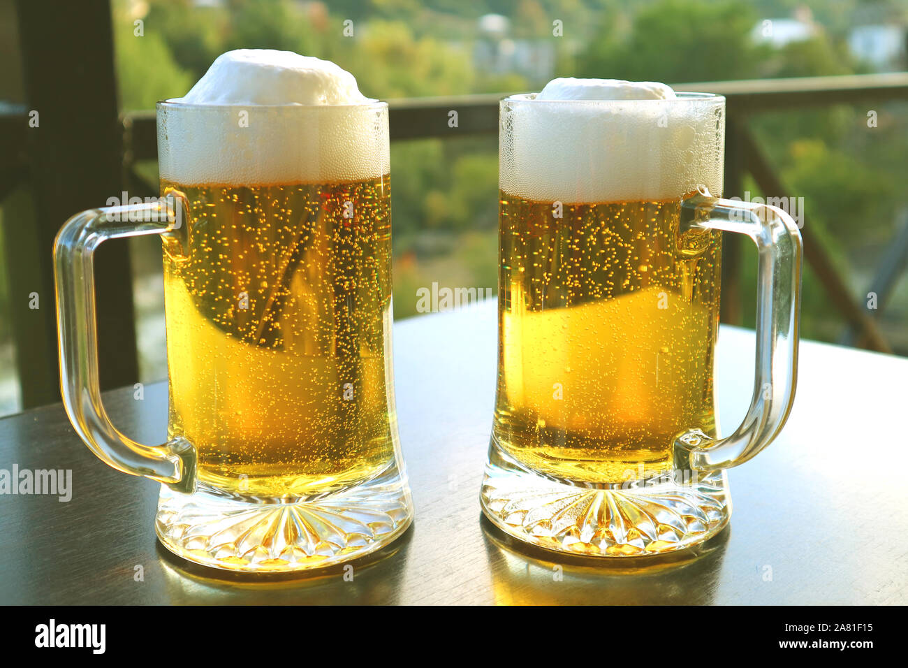 Two pints of cold beer on the table of outdoor seating Stock Photo - Alamy