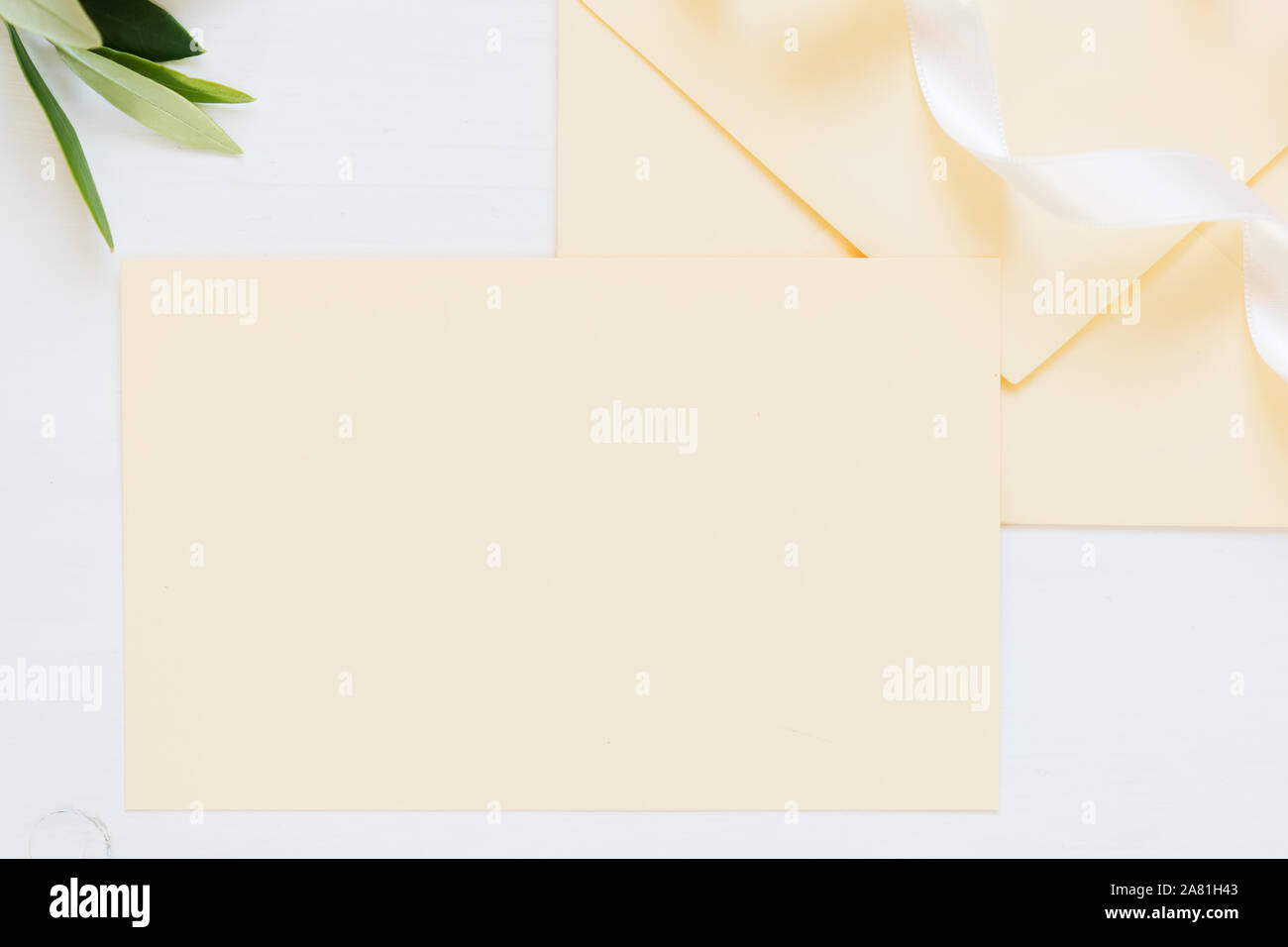 blank cream-colored envelope with ribbons, mock up for romantic ...