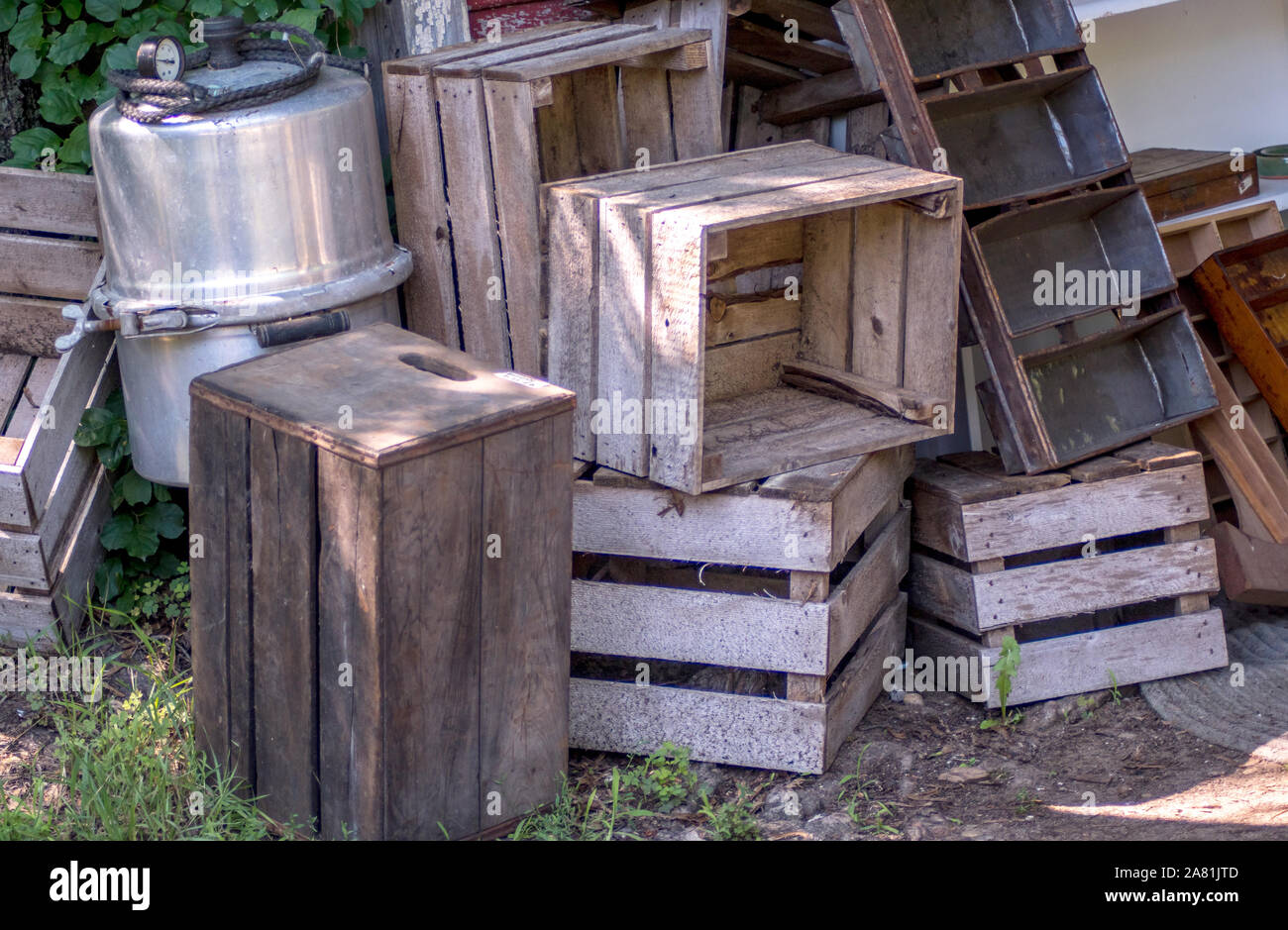 A large pile of containers include wooden boxes, crates and some ...