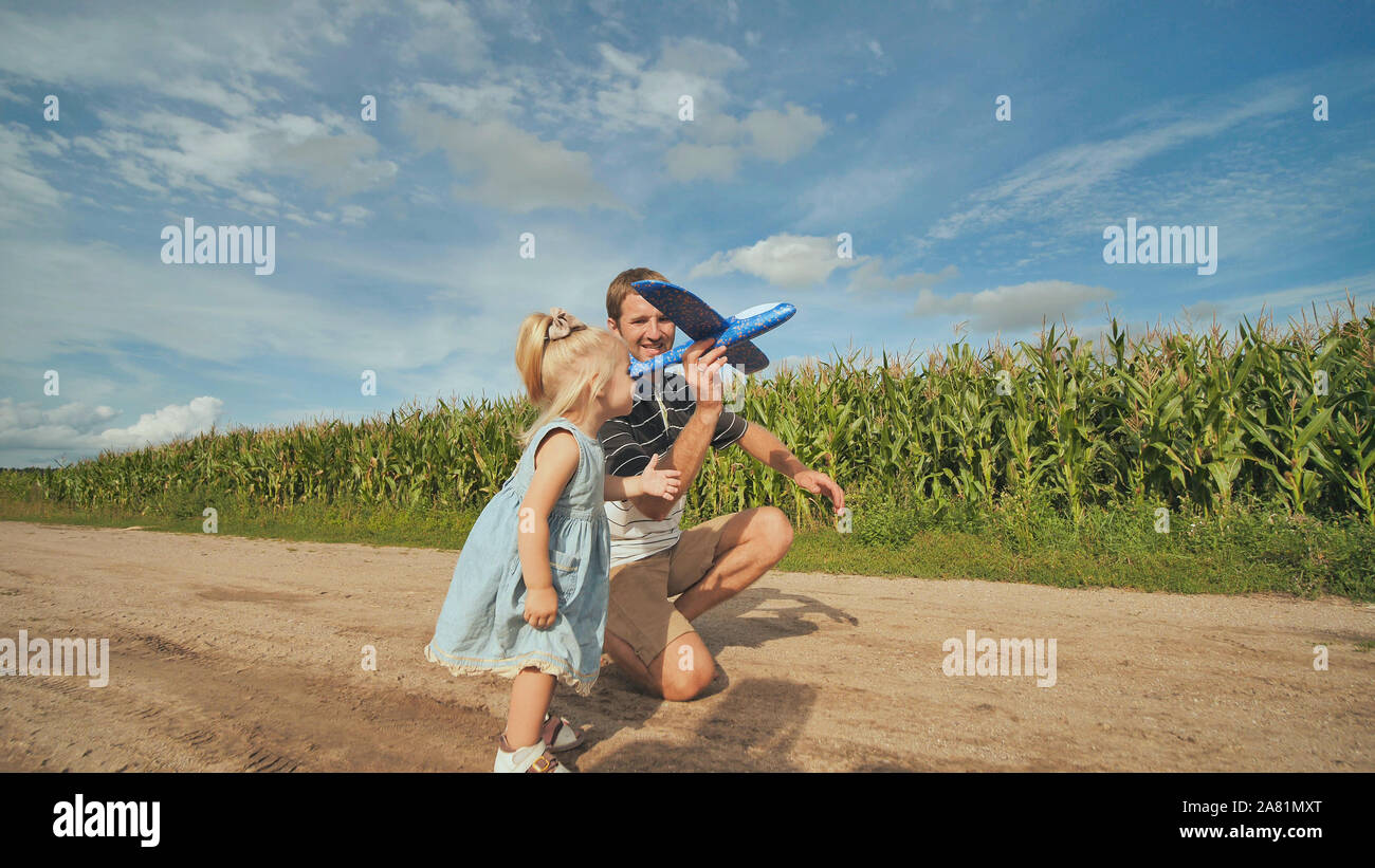 Father and little daughter launch a foam rubber toy airplane Stock ...