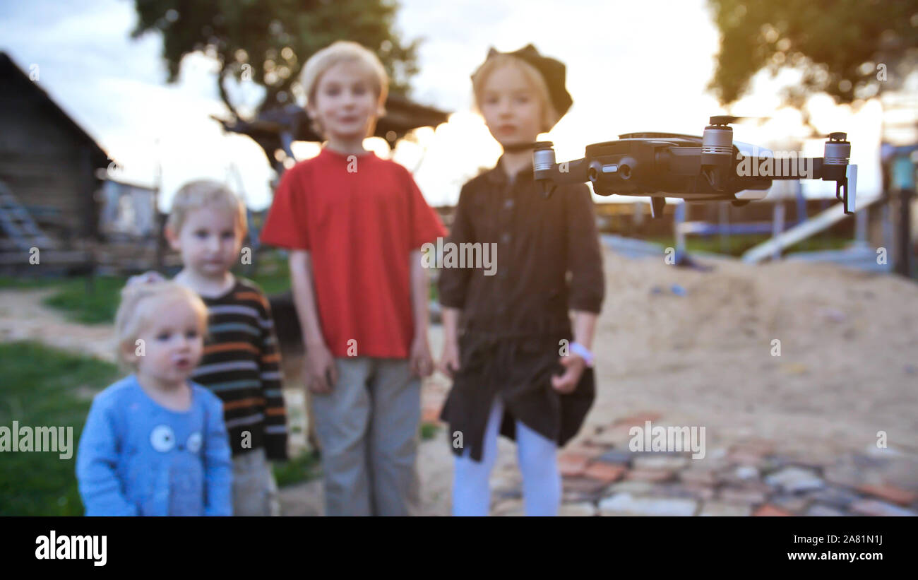 Children are watching the flying drone Stock Photo - Alamy