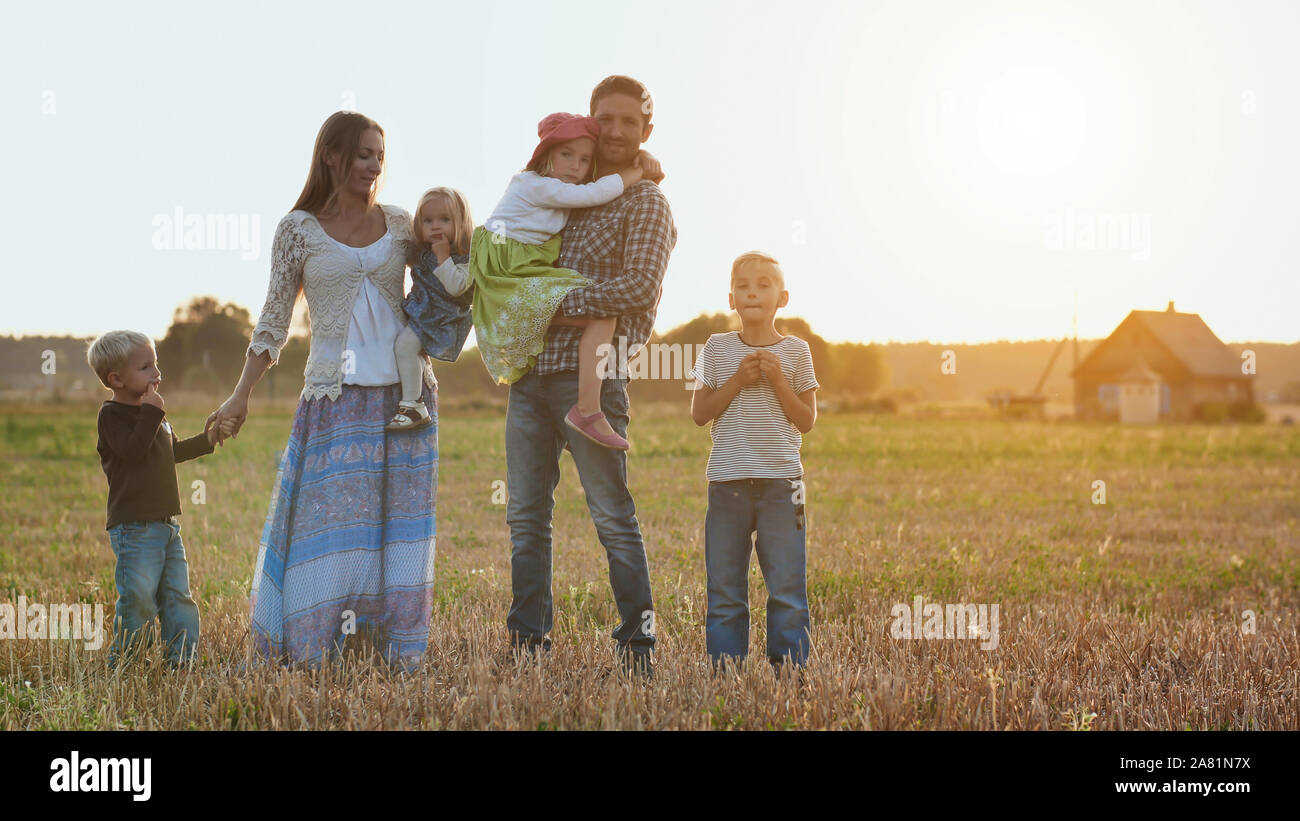 Large family on a background of evening sunset Stock Photo - Alamy