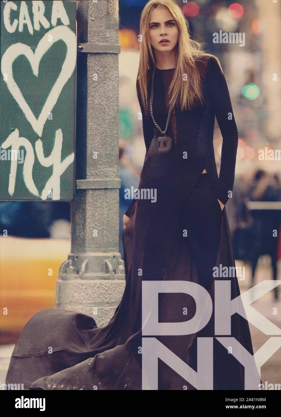 poster advertising DKNY fashion house with Cara Delevingne in paper ...
