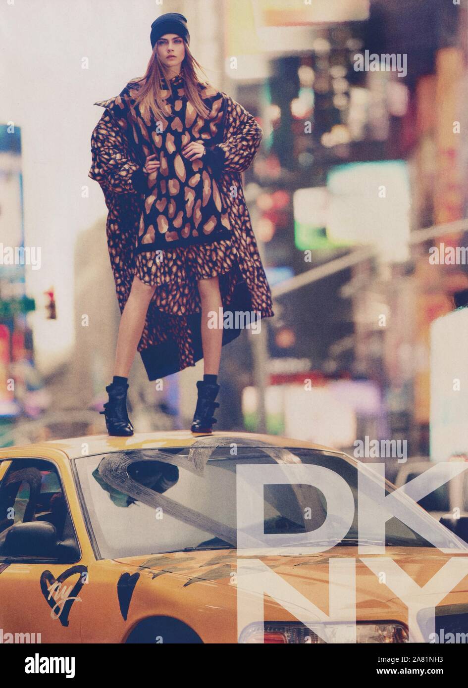 poster advertising DKNY fashion house with Cara Delevingne in paper ...
